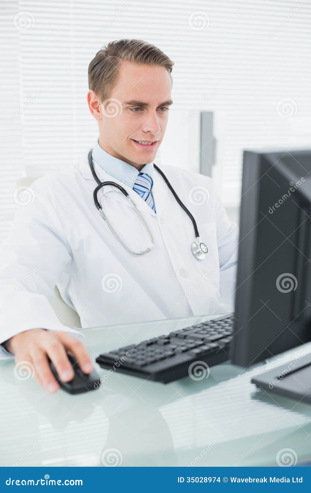 Male Doctor Using Computer at Medical Office Stock Photo - Image of ...