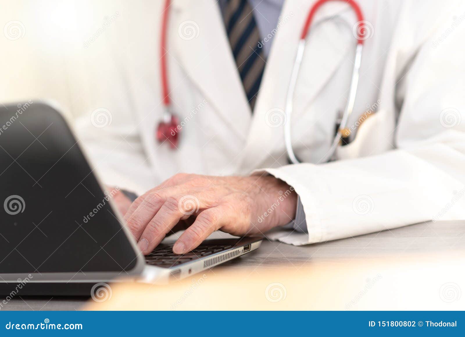 Male doctor using laptop stock photo. Image of professional - 151800802