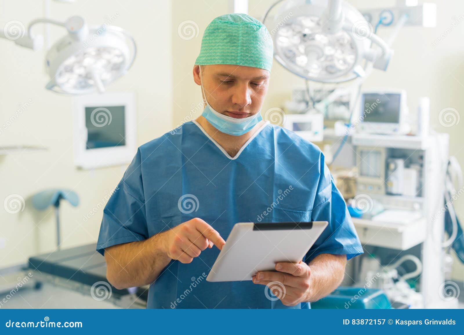 Male Doctor Using Tablet Computer in Operation Room Stock Image - Image ...