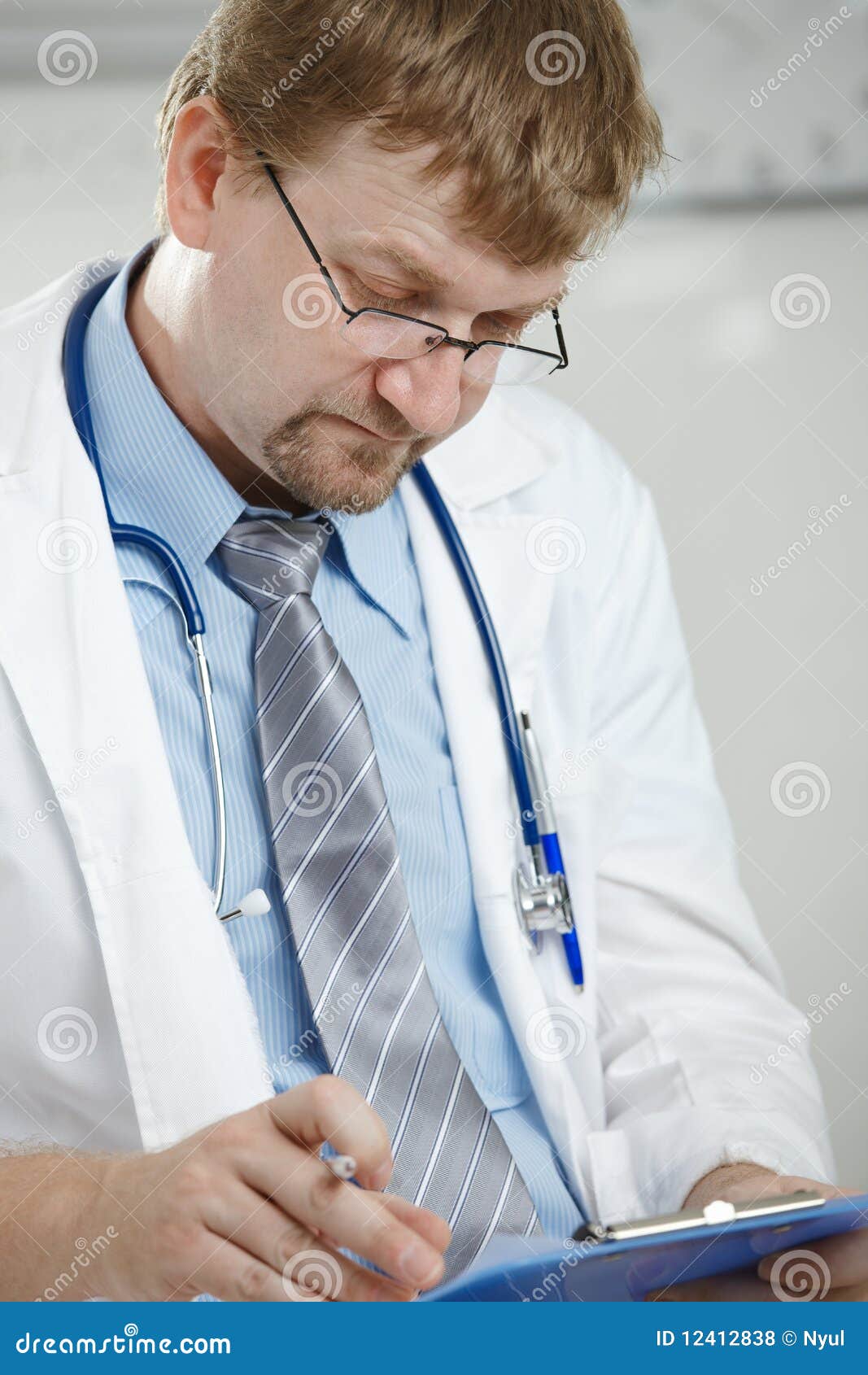 Male doctor working stock photo. Image of healing, clipboard - 12412838