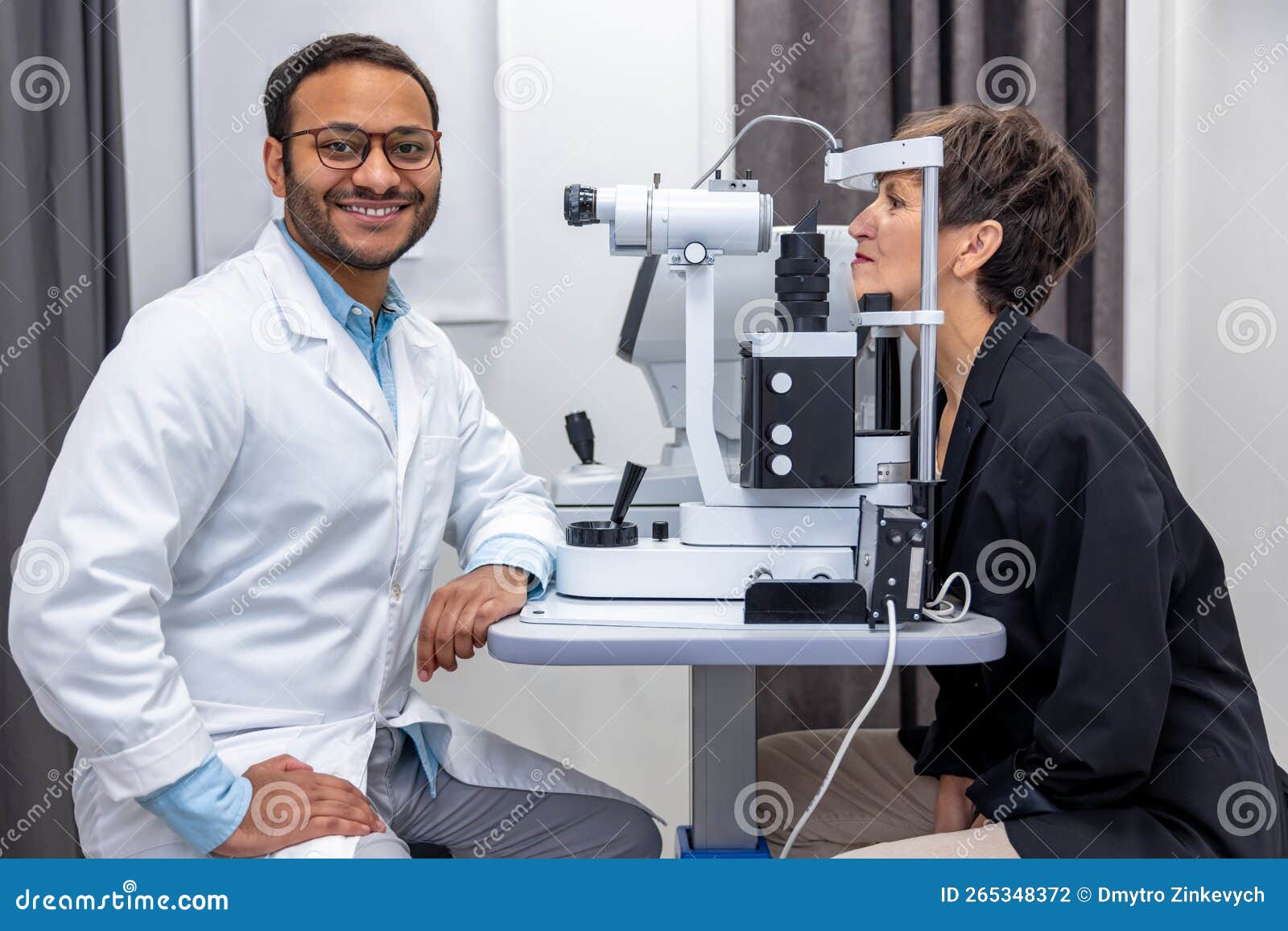 Male Doctor Working on Optometric Equipment at Clinic Stock Photo ...