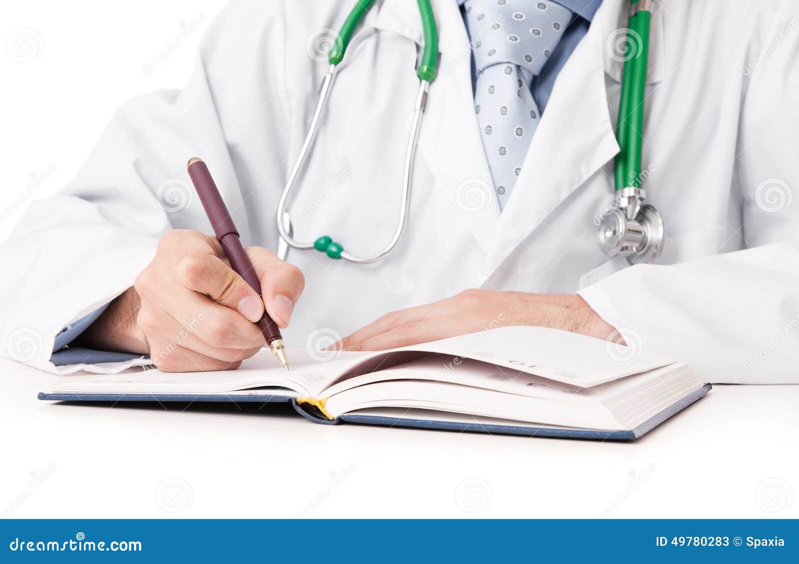 Male Doctor Writing on a Notepad in His Office Stock Image - Image of ...
