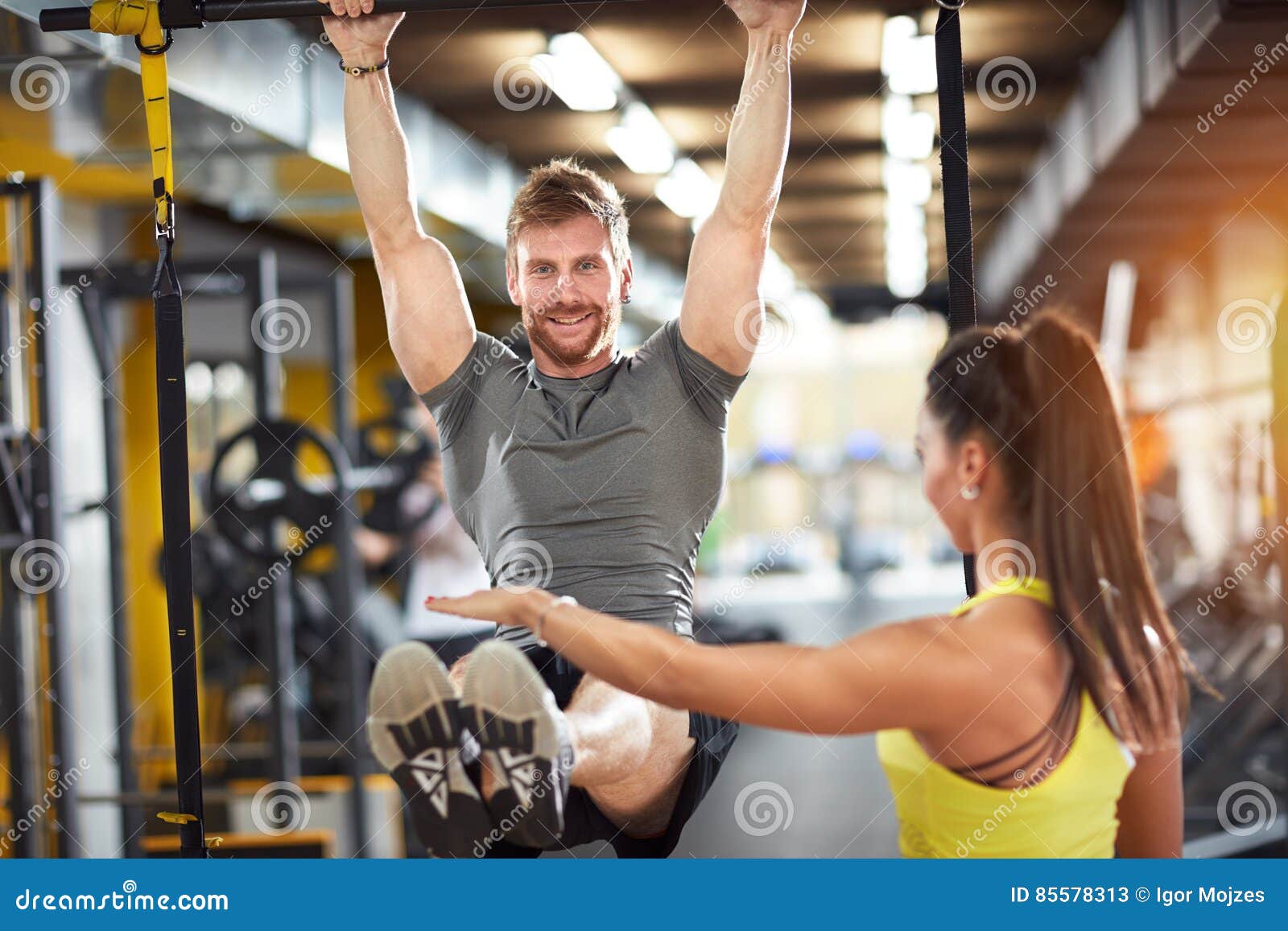 Male Doing Pull-up Exercise with Coach Assisting Stock Image - Image of ...