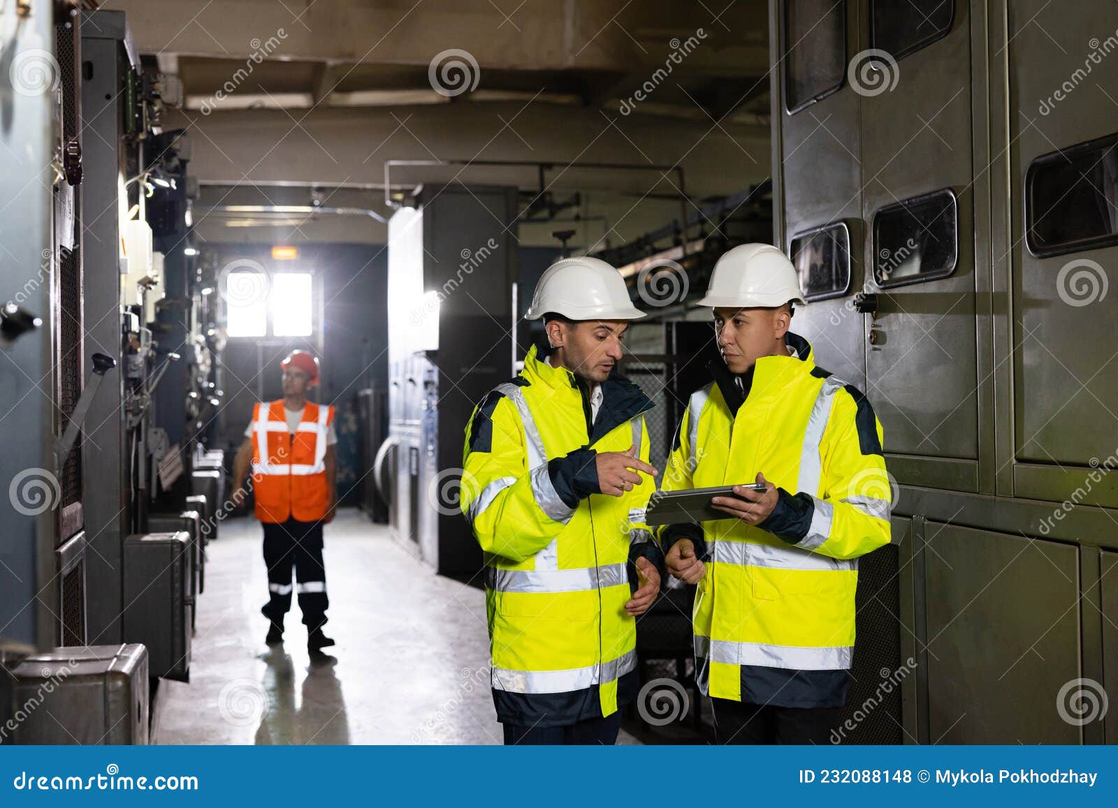 Male Electrical Engineers in Hard Hats Discuss New Project while Using ...