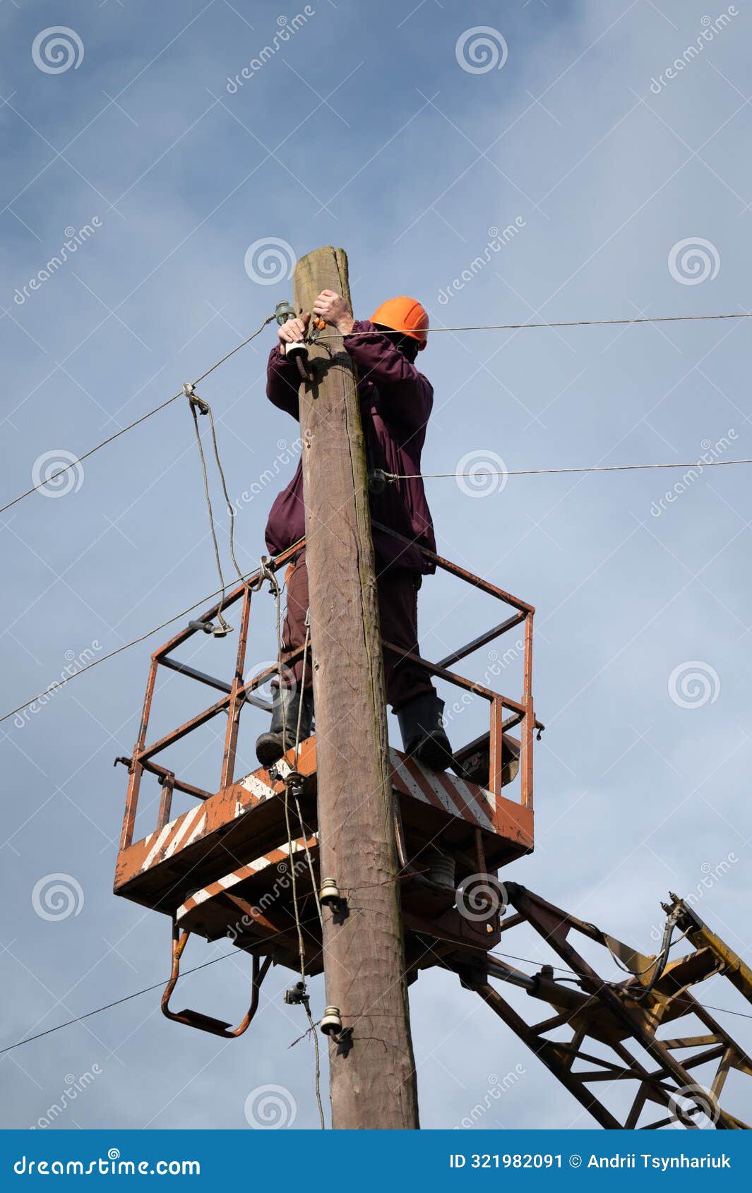 A Male Electrical Worker Repairs an Electrical Transmission Line. Stock ...