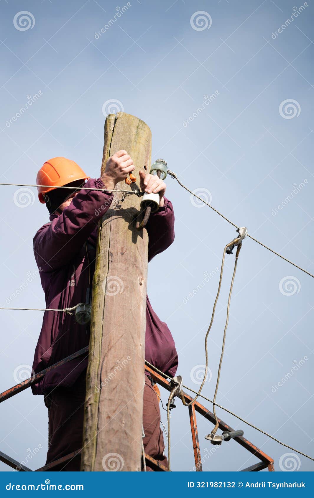 A Male Electrical Worker Repairs an Electrical Transmission Line. Stock ...