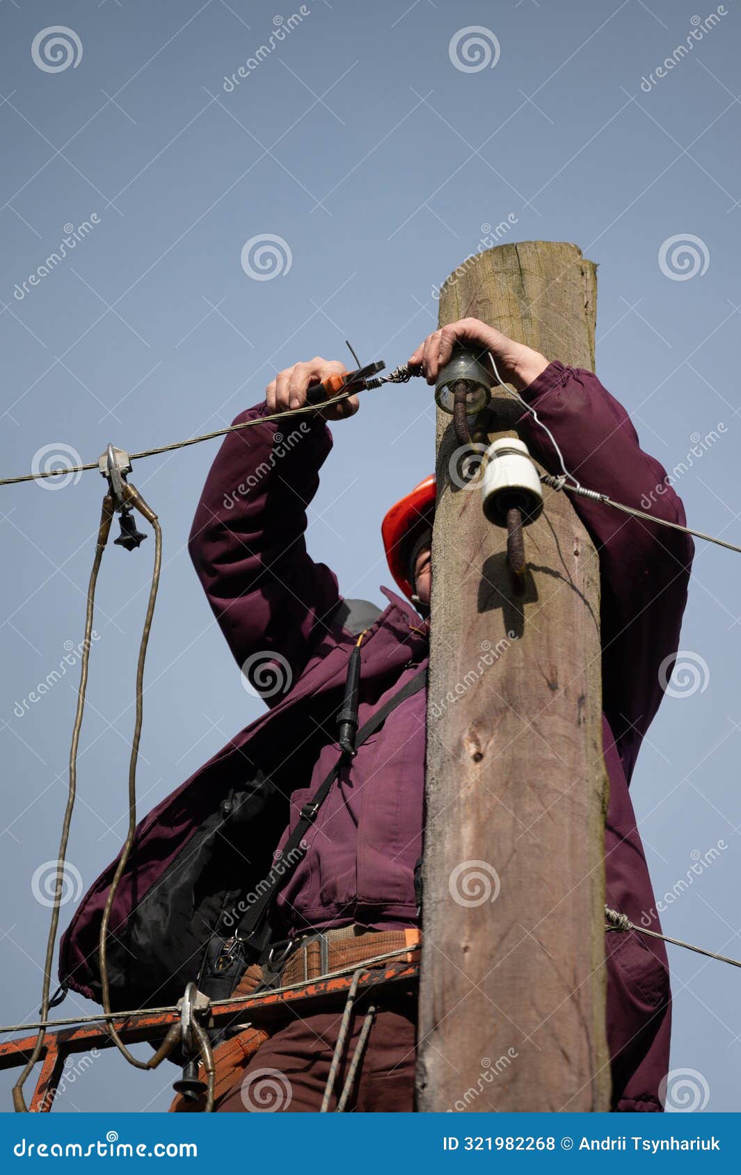 A Male Electrical Worker Repairs an Electrical Transmission Line. Stock ...