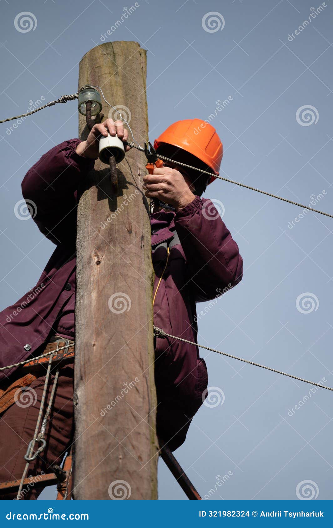 A Male Electrical Worker Repairs an Electrical Transmission Line. Stock ...
