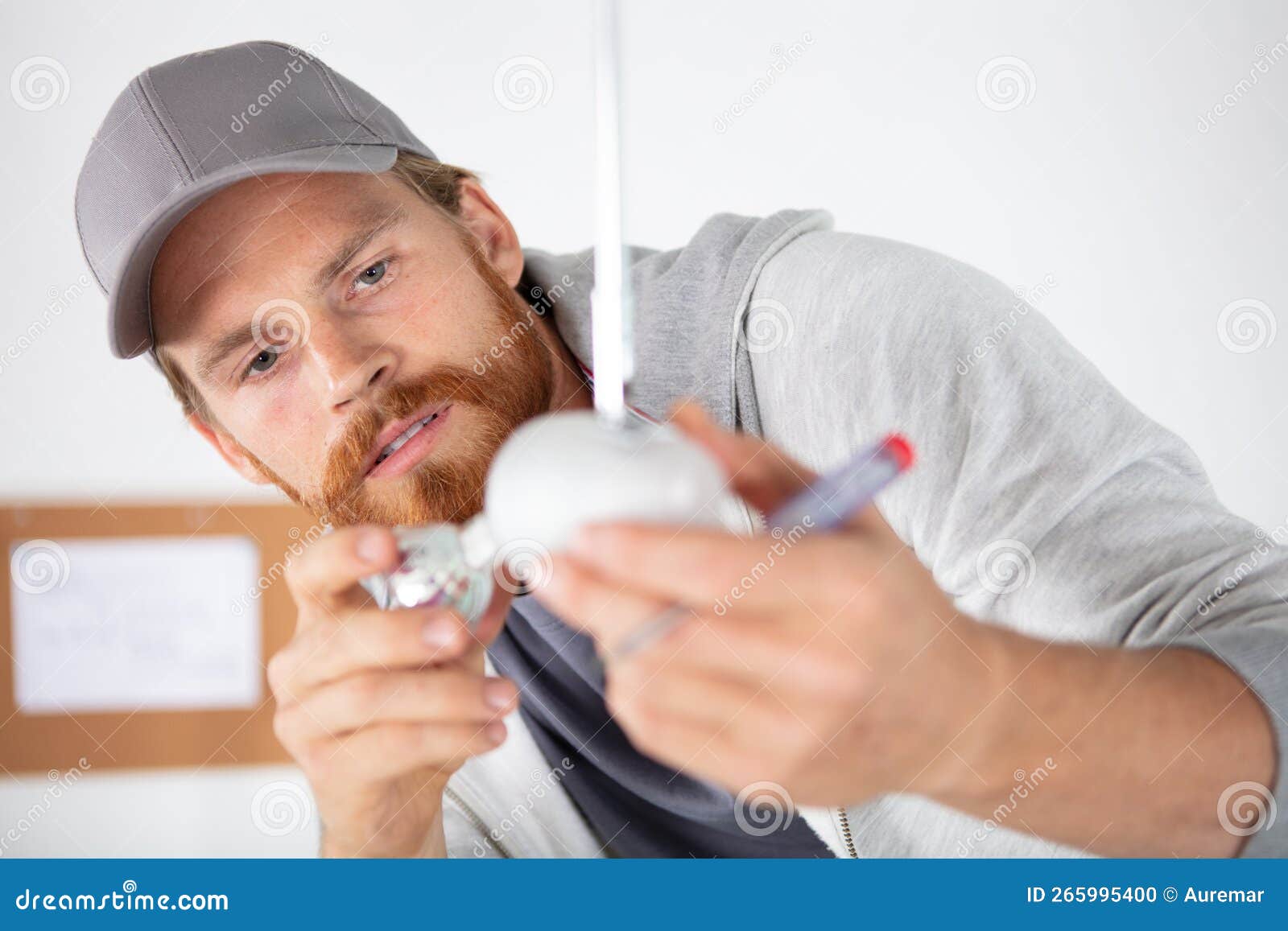 Male Electrician Changing Lamp Bulb Stock Photo - Image of electricity ...