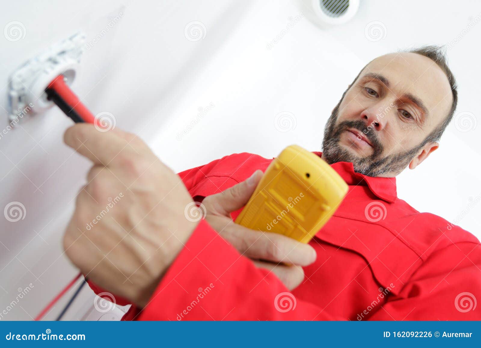 Male Electrician Checking Voltage Socket with Multimeter Stock Photo ...
