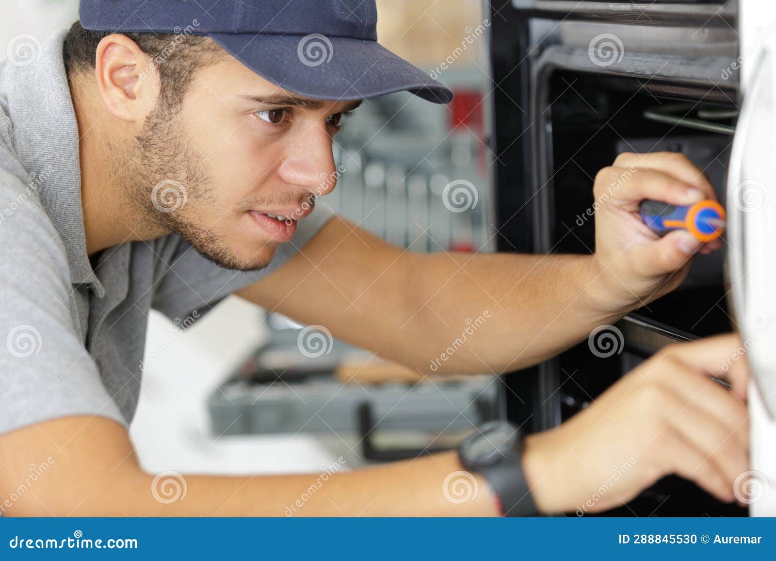 Male Electrician Fixing Oven in Kitchen Stock Photo - Image of ...