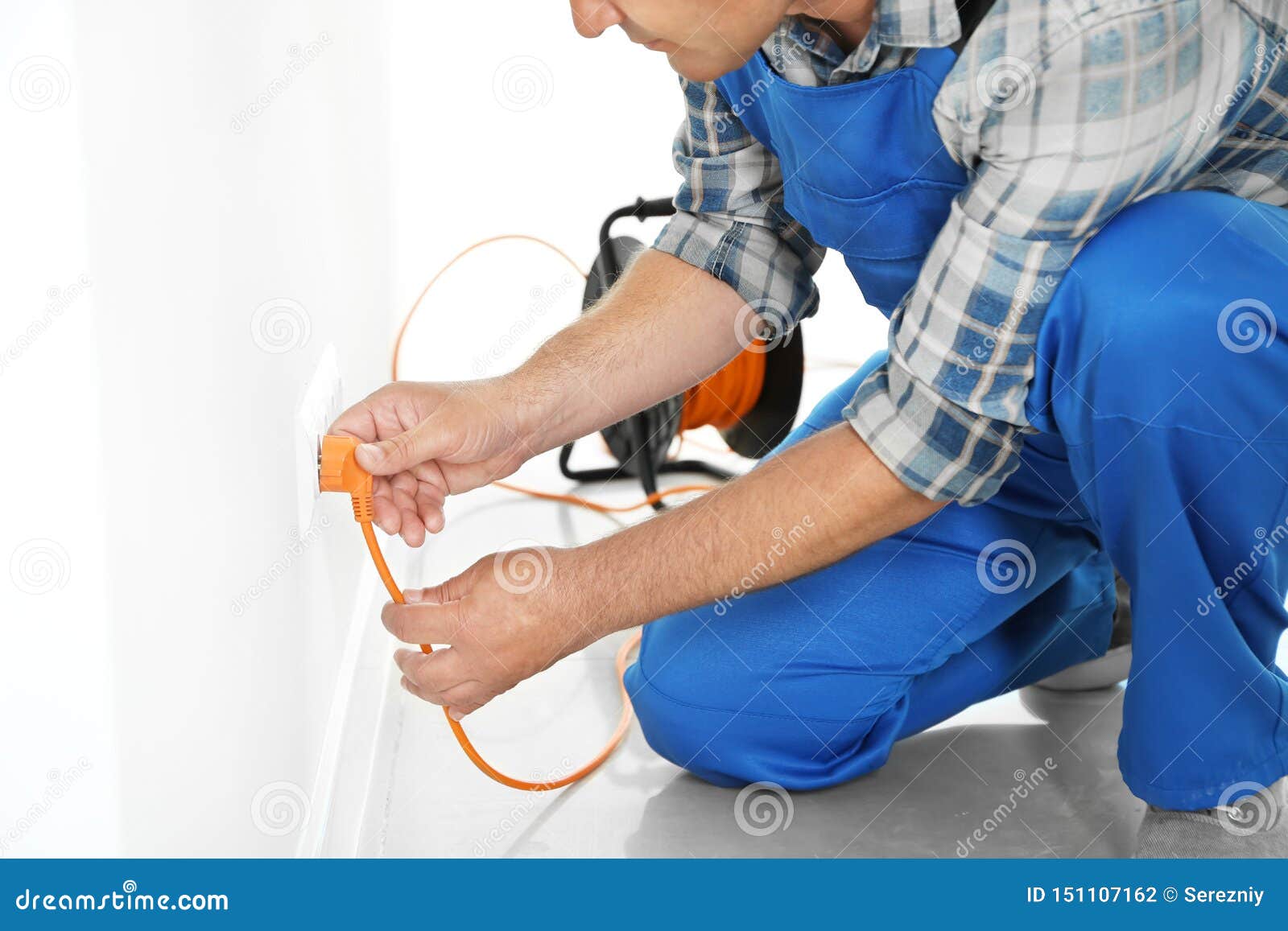Male Electrician Inserting Plug into Socket in Order To Check Its ...