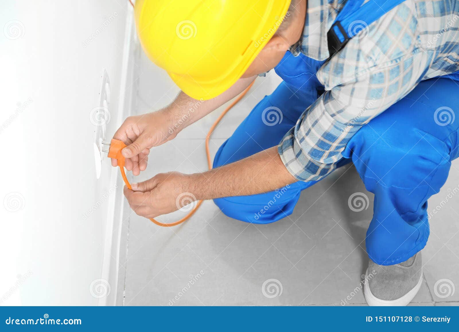 Male Electrician Inserting Plug into Socket in Order To Check Its ...