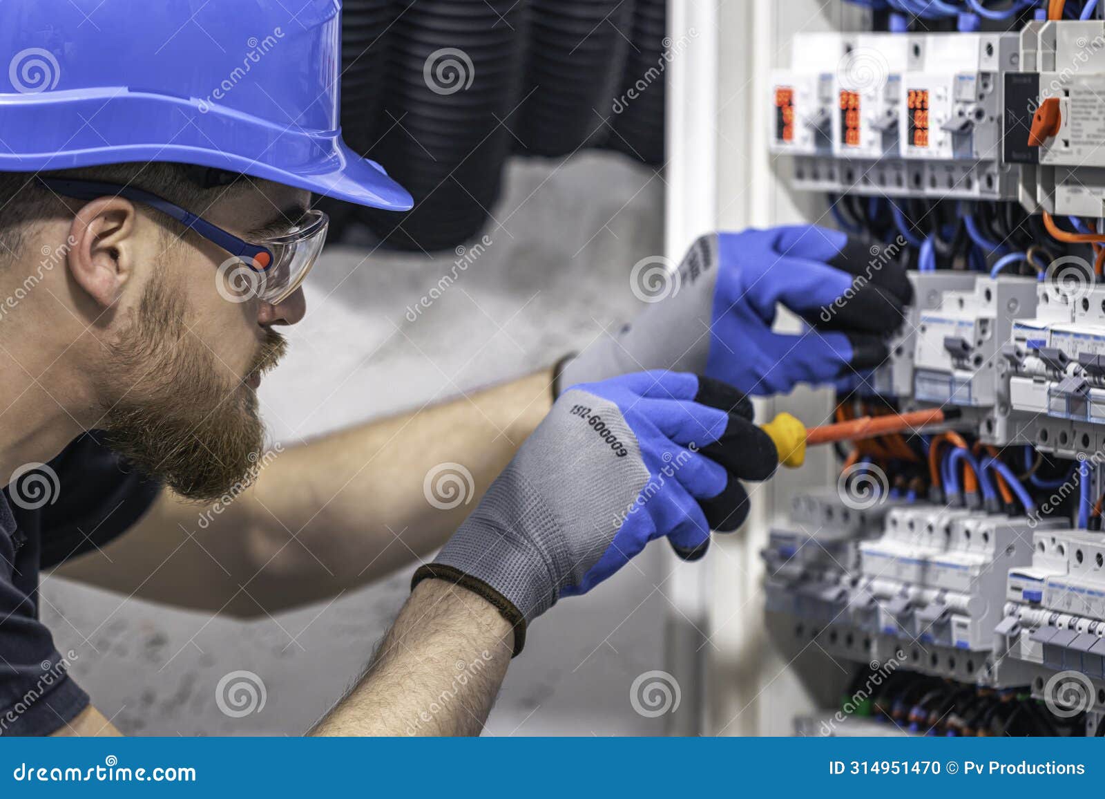 Male Electrician Working in a Switchboard with Fuses. Stock Photo ...