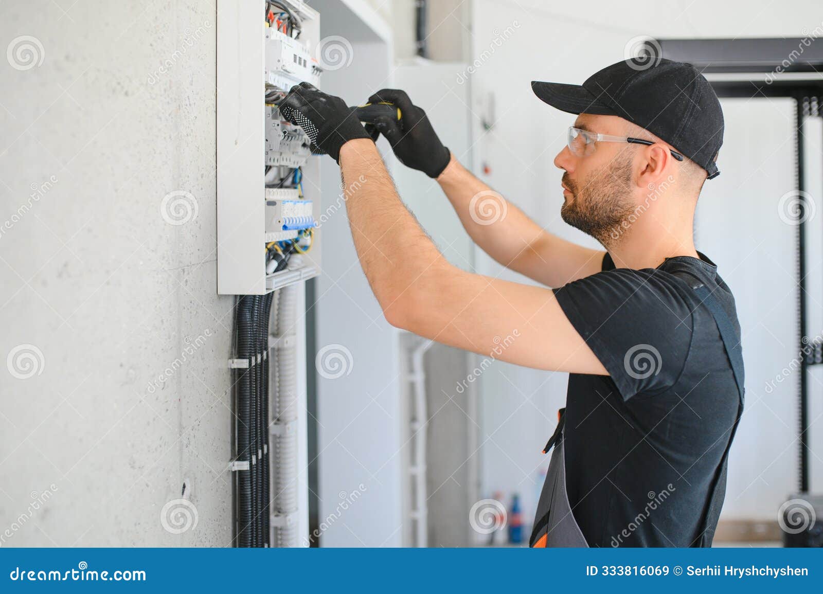 A Male Electrician Works in a Switchboard Stock Image - Image of ...