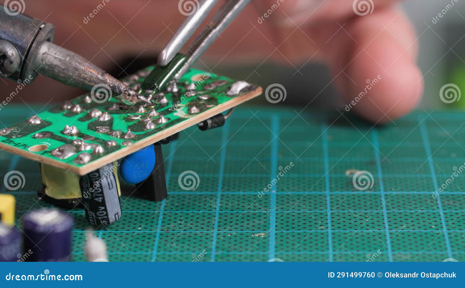Male Electronics Engineer Using a Soldering Iron Repairs Electronic ...