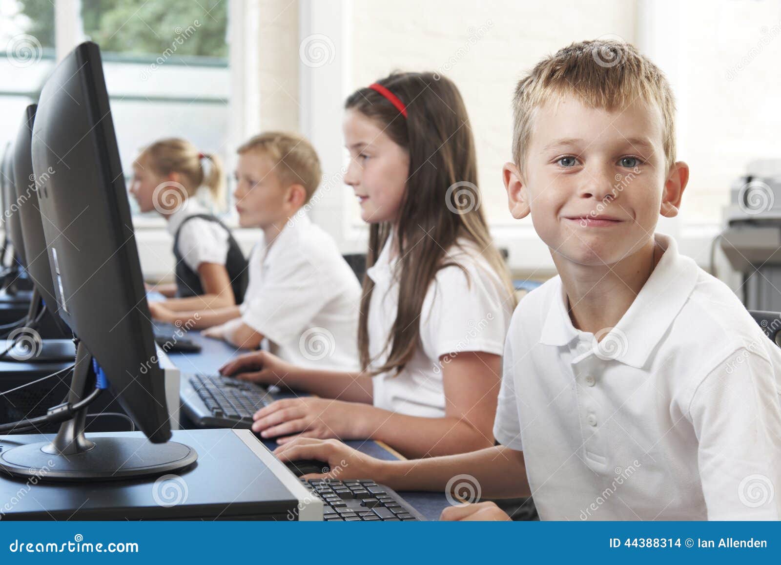 Male Elementary Pupil in Computer Class Stock Photo - Image of girl ...