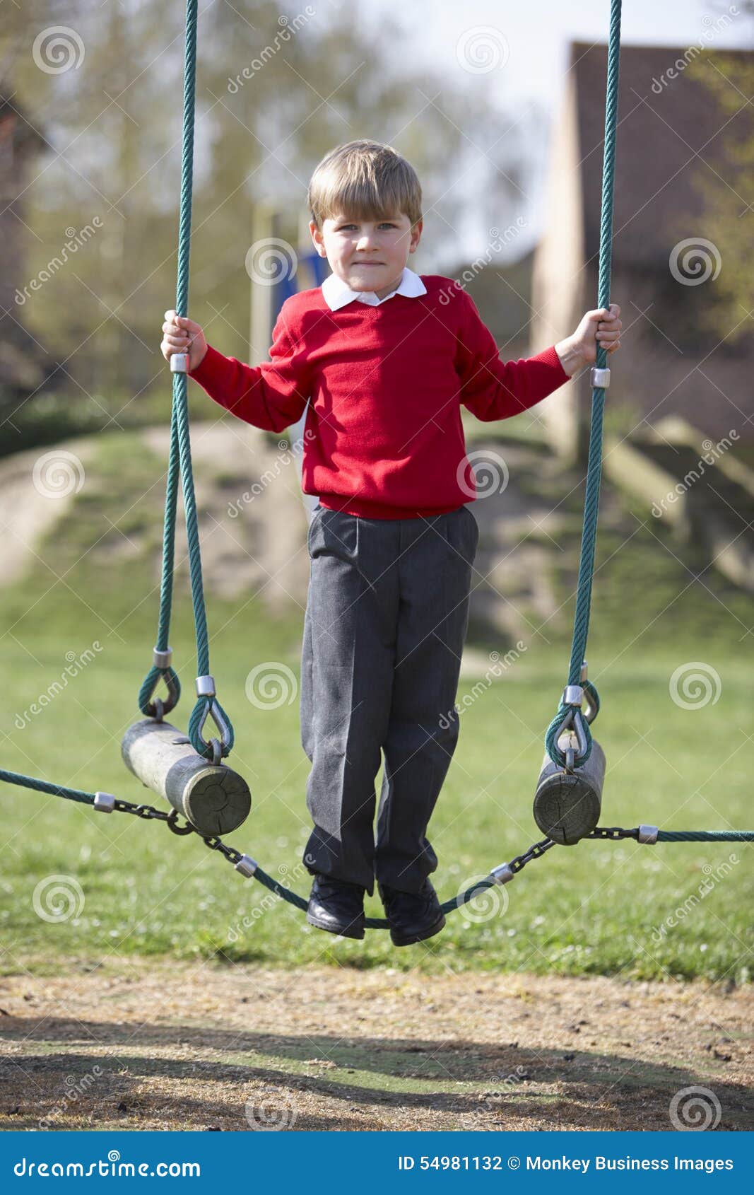 Male Elementary School Pupil on Climbing Equipment Stock Photo - Image ...