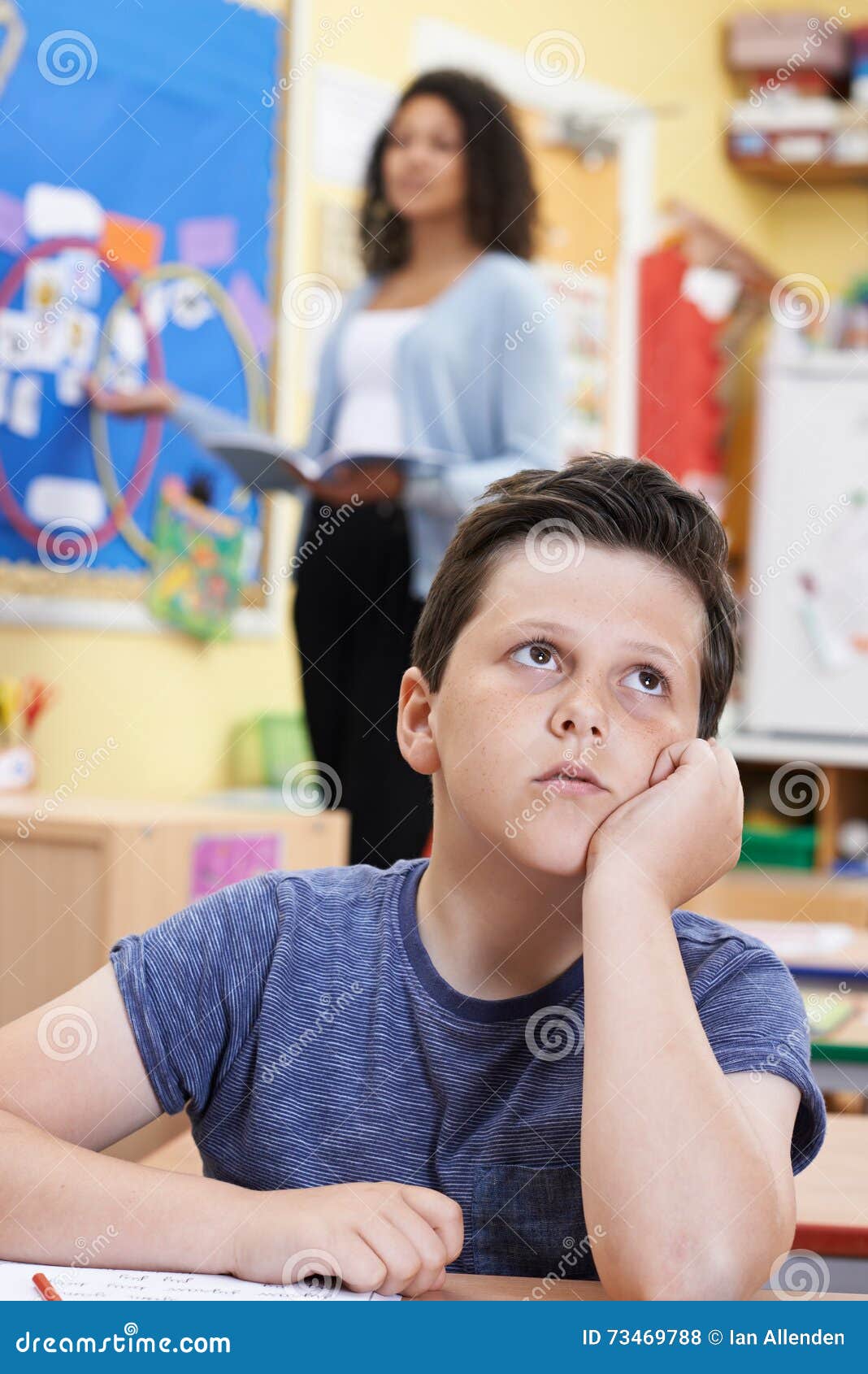 Male Elementary School Pupil Daydreaming in Class Stock Photo - Image ...