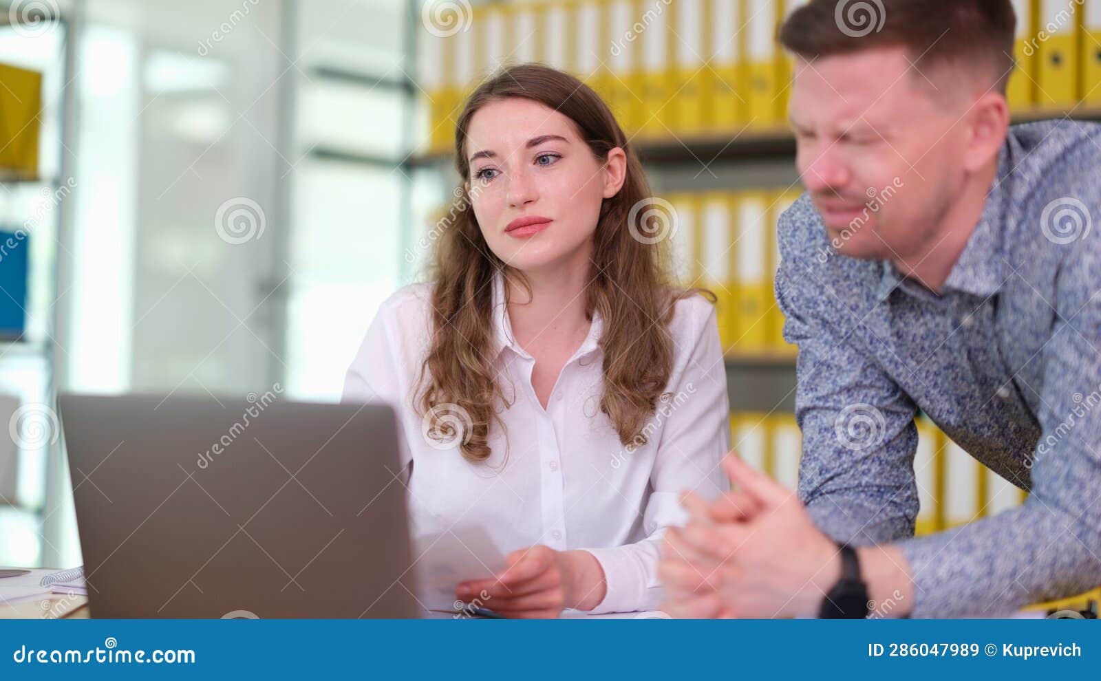 Male Employee and Female Manager are Studying a Report on Laptop Stock ...
