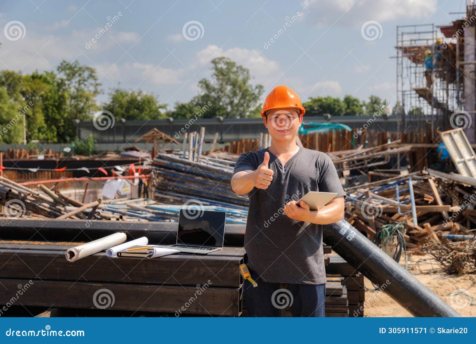 Male Engineer with Arms Crossed Standing at a Construction Site Looking ...