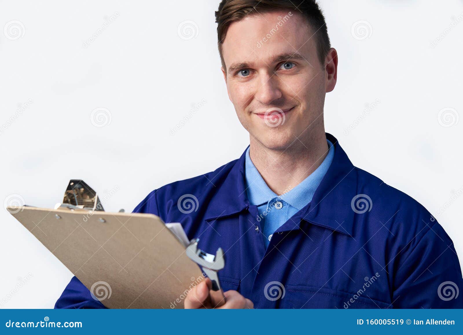 Studio Portrait of Male Engineer with Clipboard and Spanner Against ...