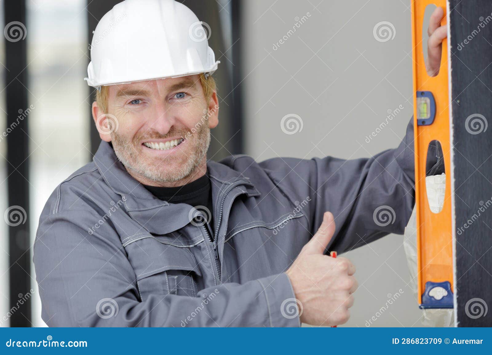Male Engineer in Hard Hat Holding Level Tool and Gesturing Stock Image ...
