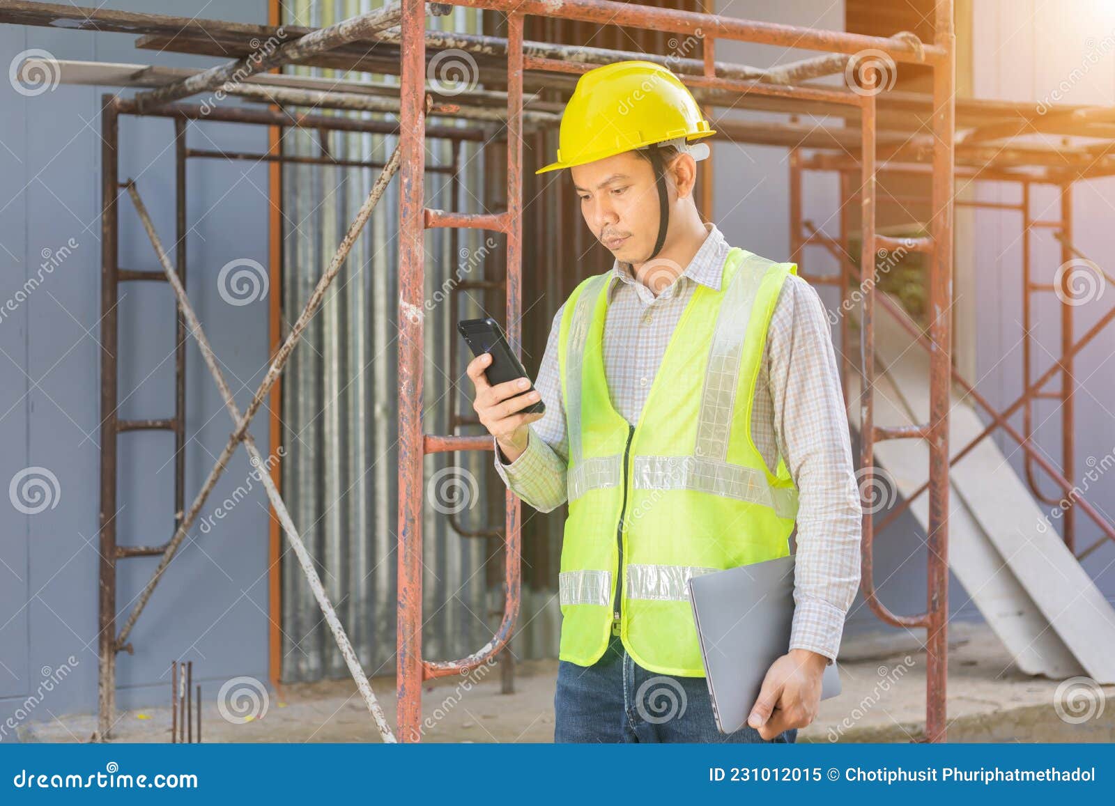 A Male Engineer Looks at the Floor Plan at the Construction Site Stock ...