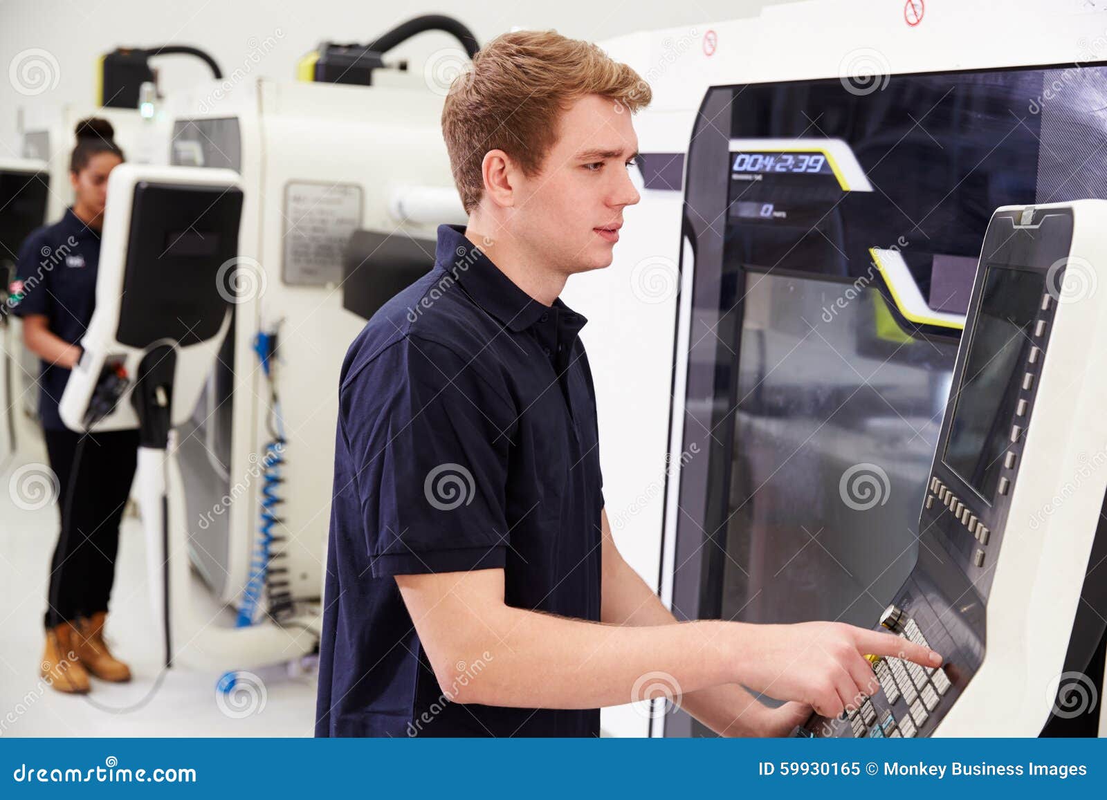 Male Engineer Operating CNC Machinery on Factory Floor Stock Image ...