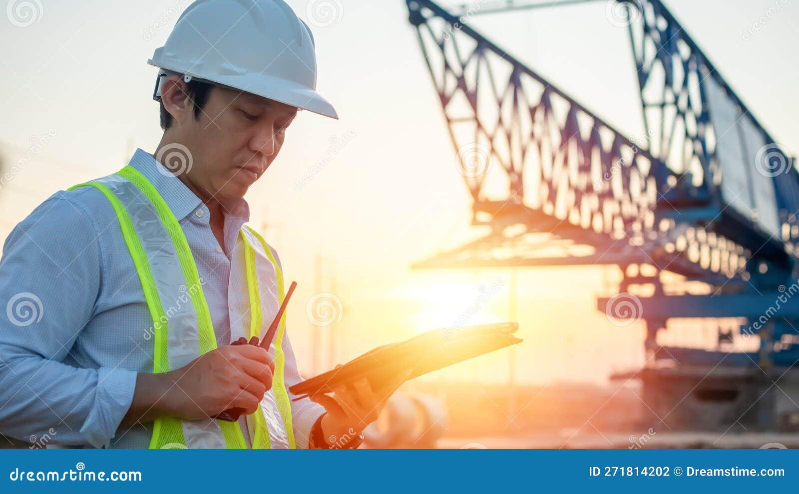 Male Engineer Talking on Walkie-talkie and Using Tablet for Working at ...