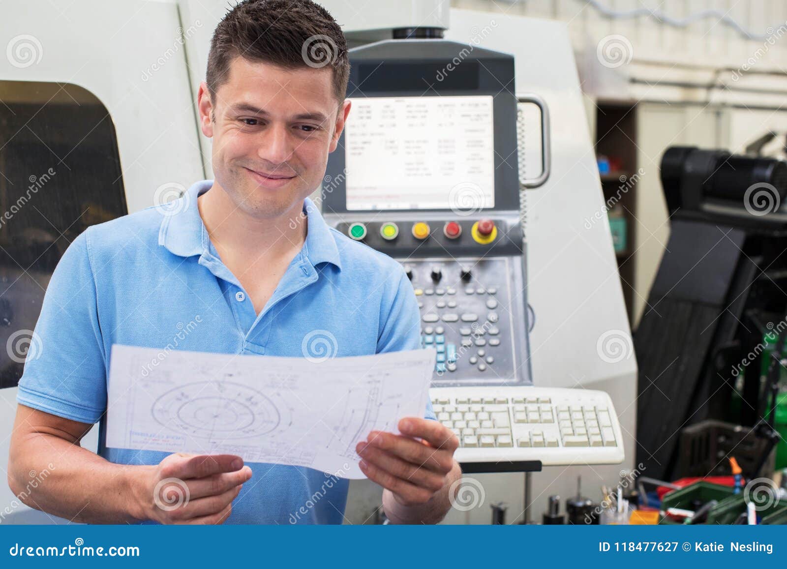 Male Engineer with Technical Drawing Operating CNC Machine in Fa Stock ... Male Engineer with Technical Drawing Operating CNC Machine in Fa Stock ...