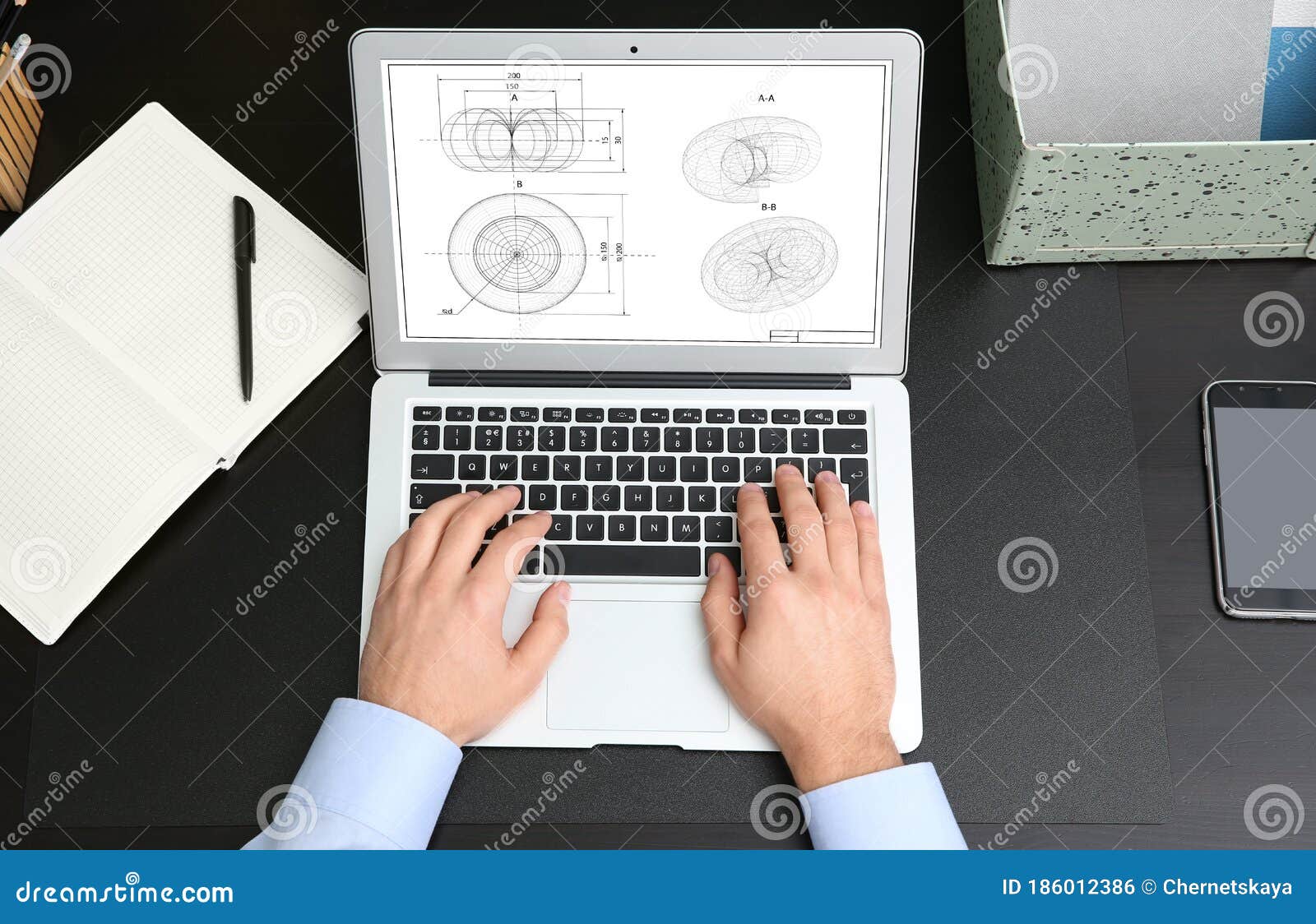 Male Engineer Working with Technical Drawing on Laptop at Table Stock ...