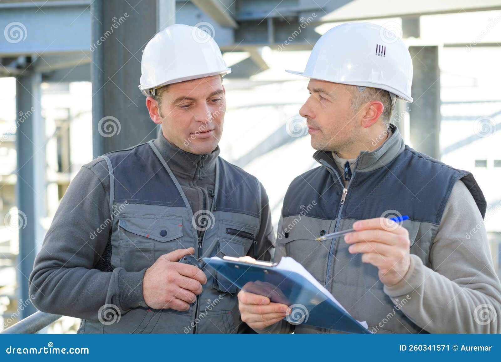 2 Male Engineers with Clipboard Looking at Clipbord Stock Image - Image ...
