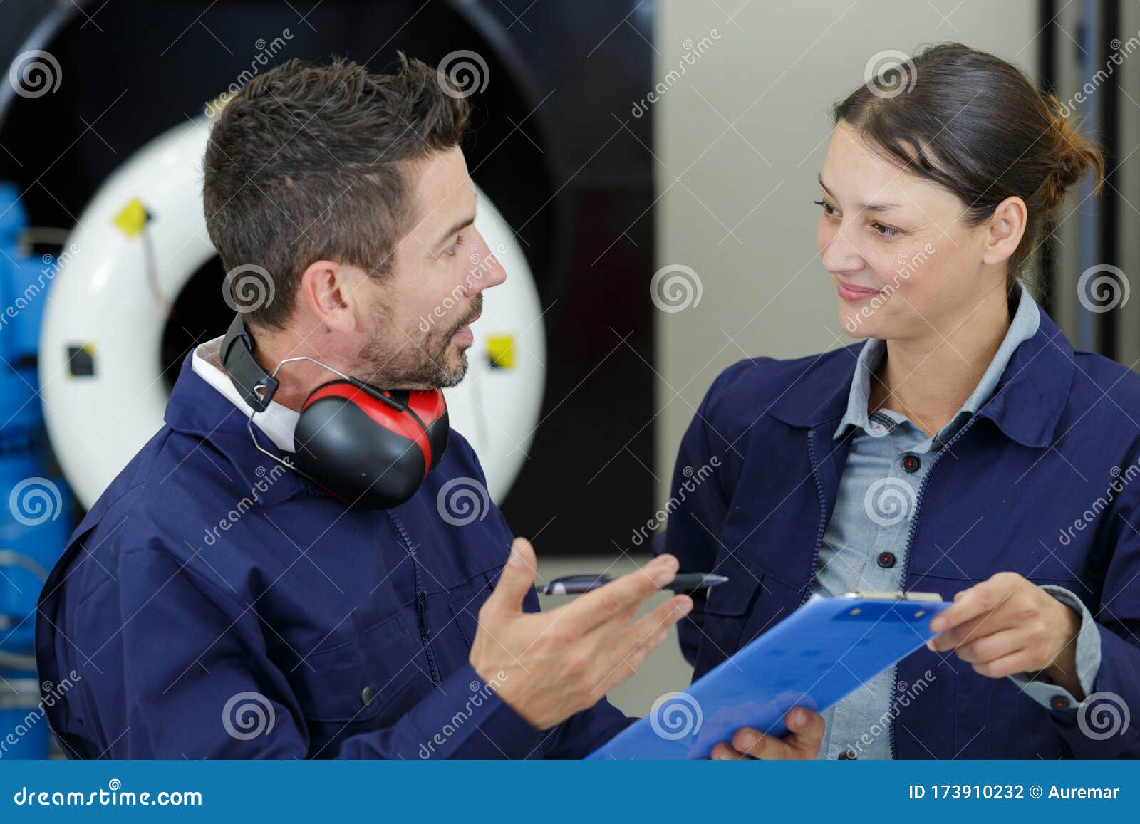 Male Engineers and Technician Talking Over Clipboard Stock Photo ...