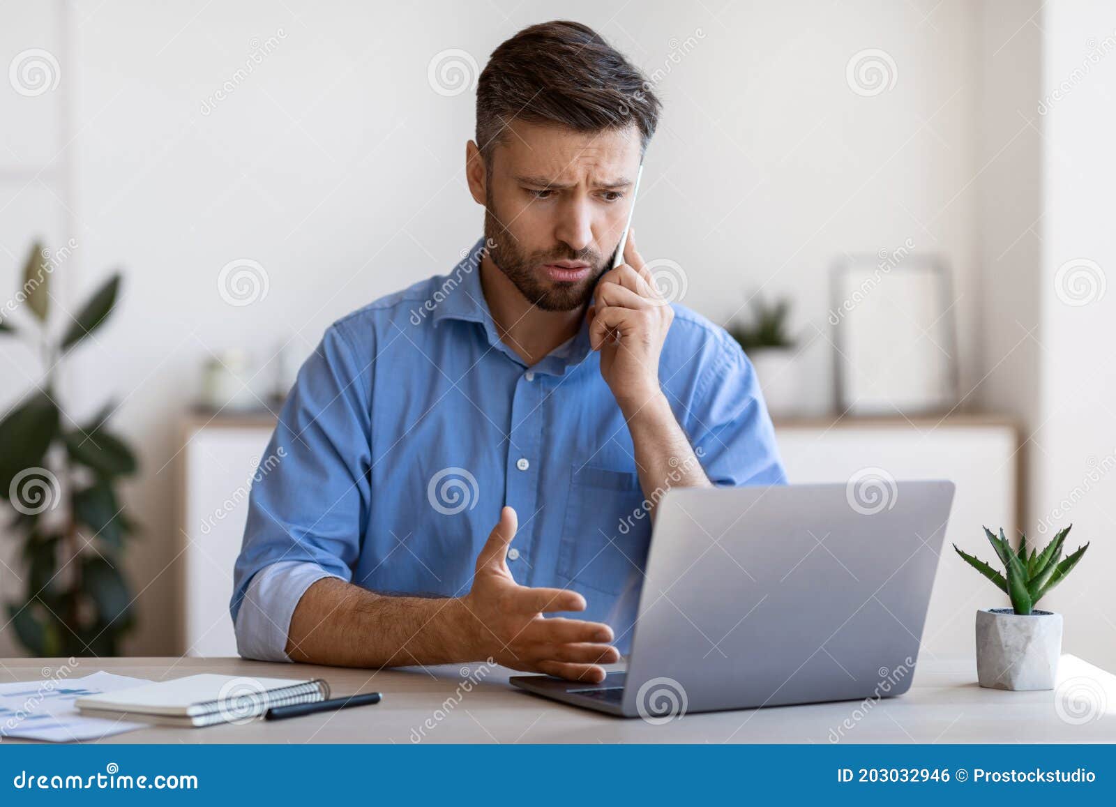 Male Entrepreneur Having Problems with Computer at Work, Talking with ...