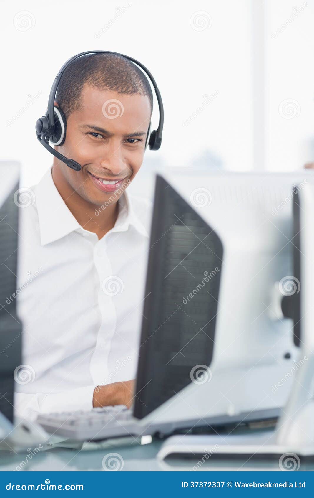Male Executive with Headset Using Computer at Desk Stock Image - Image ...