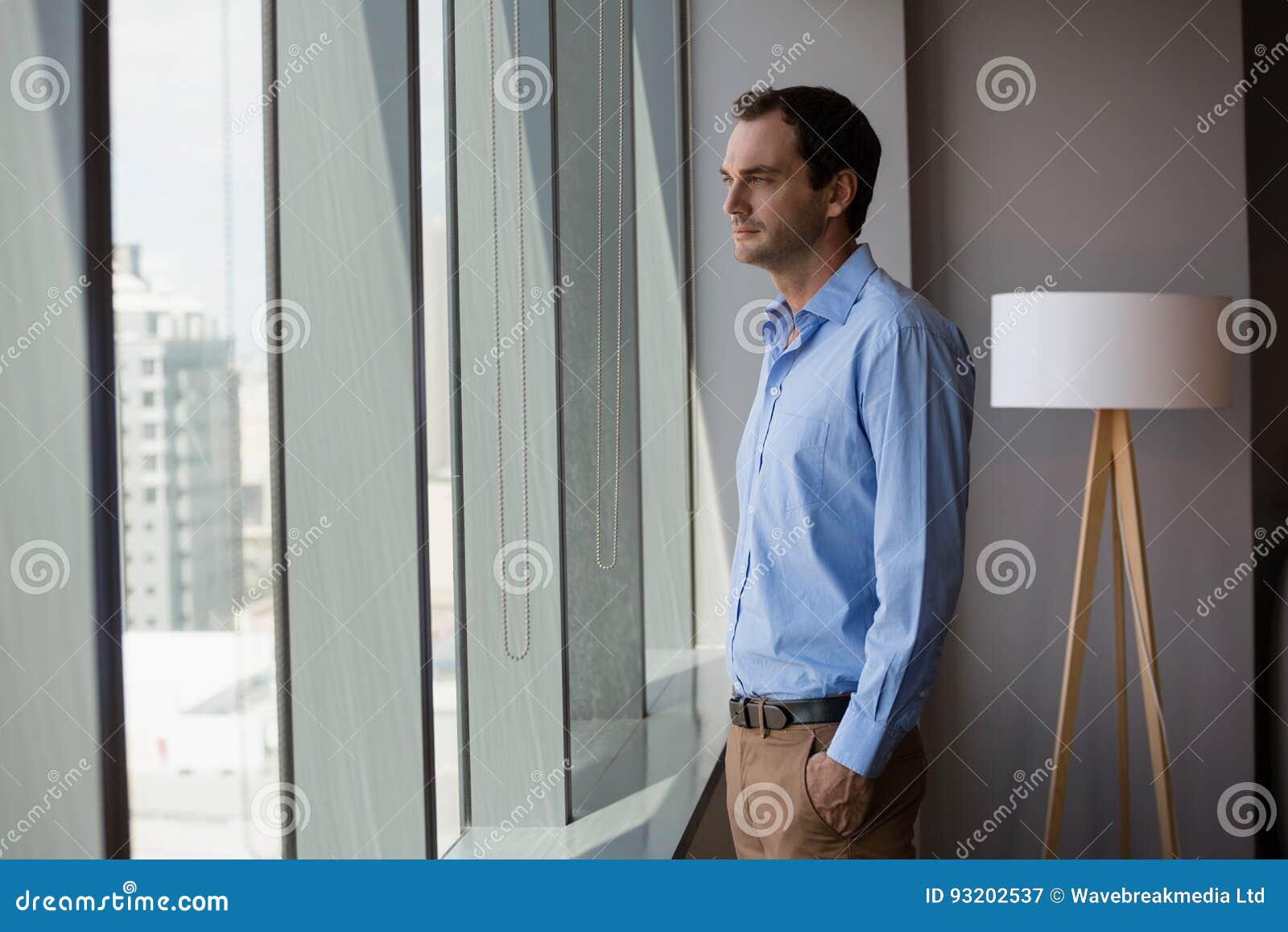 Male Executive Looking through Window in Office Stock Image - Image of ...