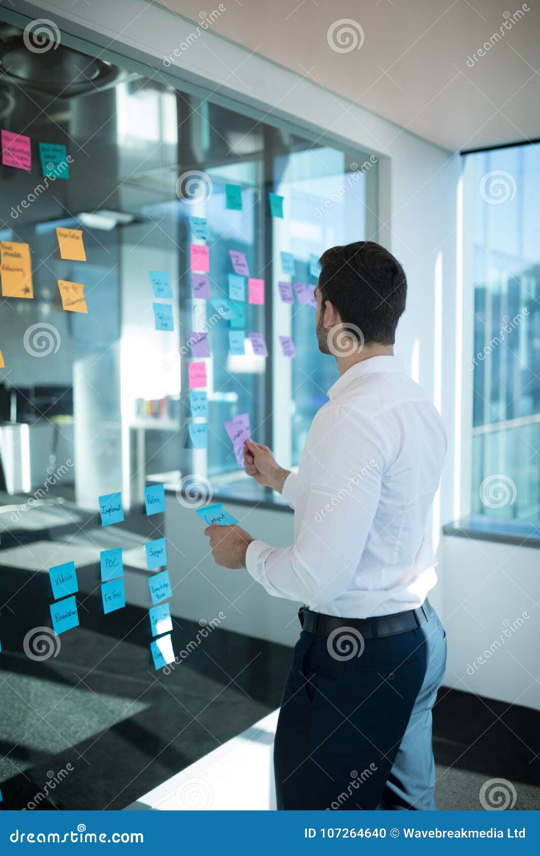 Male Executive Reading Sticky Note Stock Photo - Image of company ...