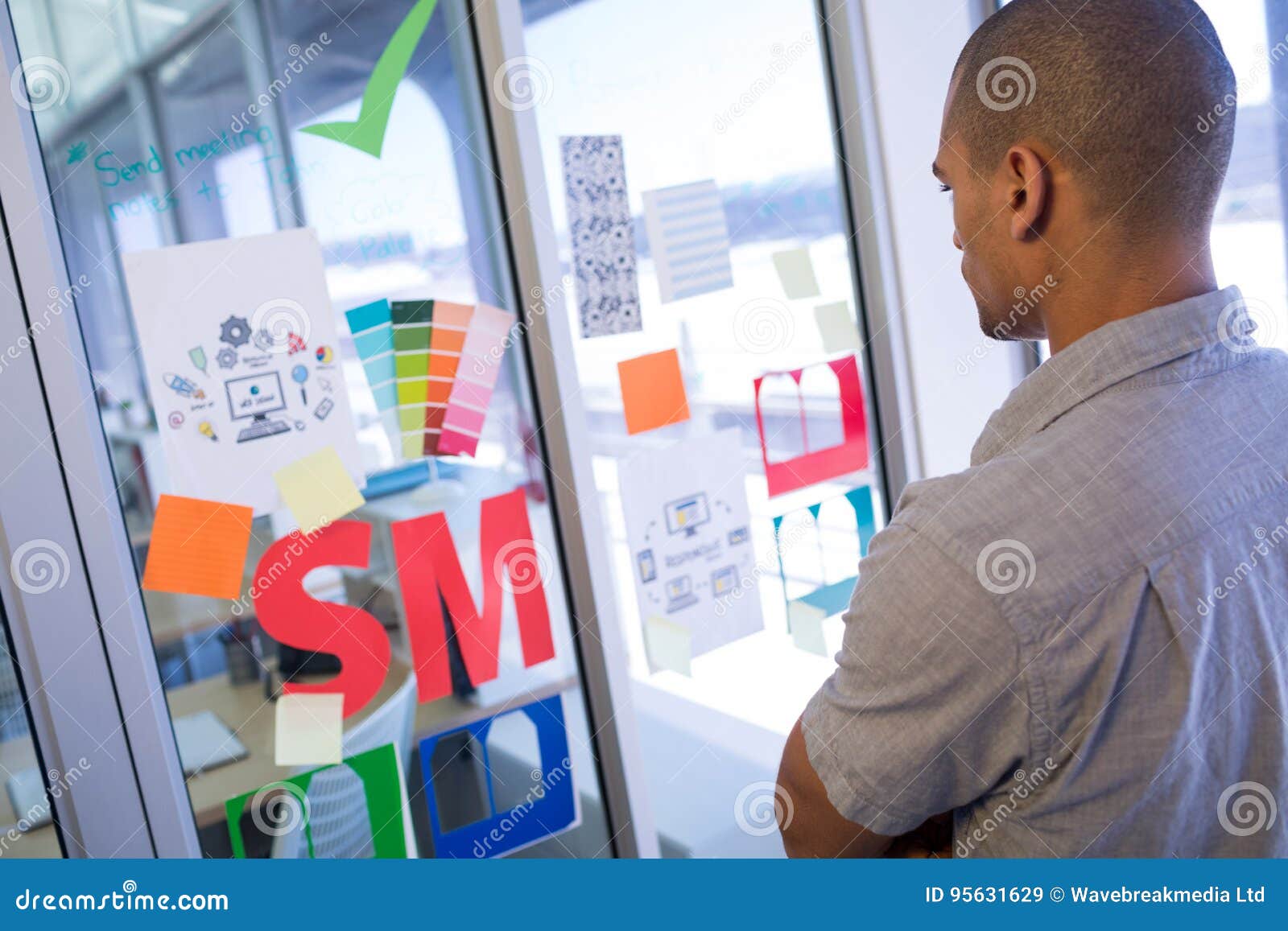 Male Executive Reading Sticky Notes on Glass Door Stock Image - Image ...