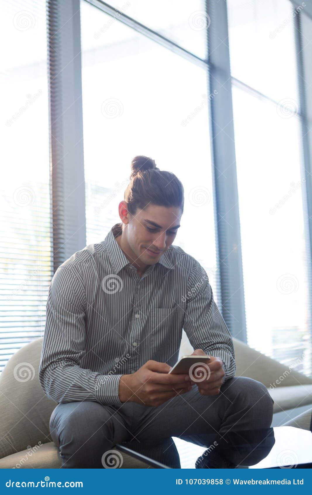 Male Executive Using Mobile Phone in Waiting Area Stock Photo - Image ...