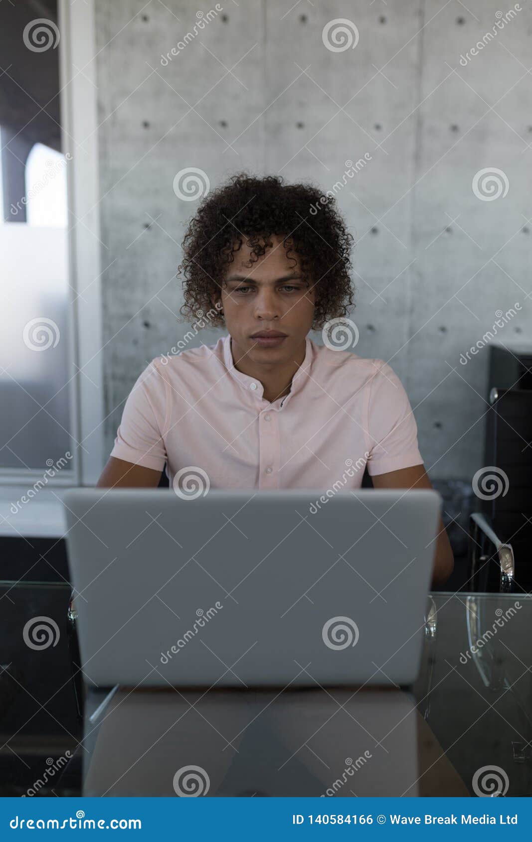 Male Executive Working on Laptop at Table in Office Stock Photo - Image ...