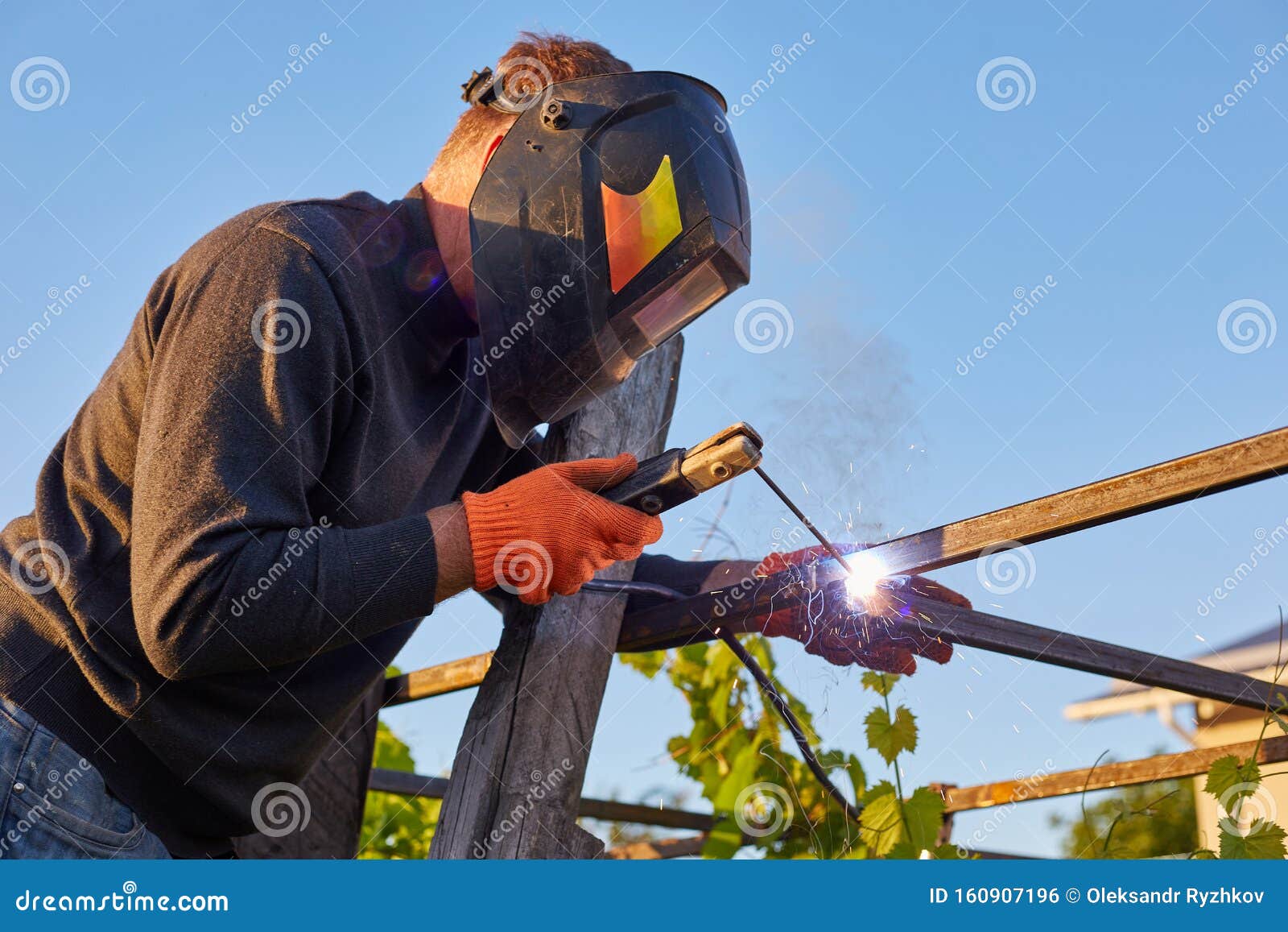 Male in face mask welds stock photo. Image of hire, industrial - 160907196