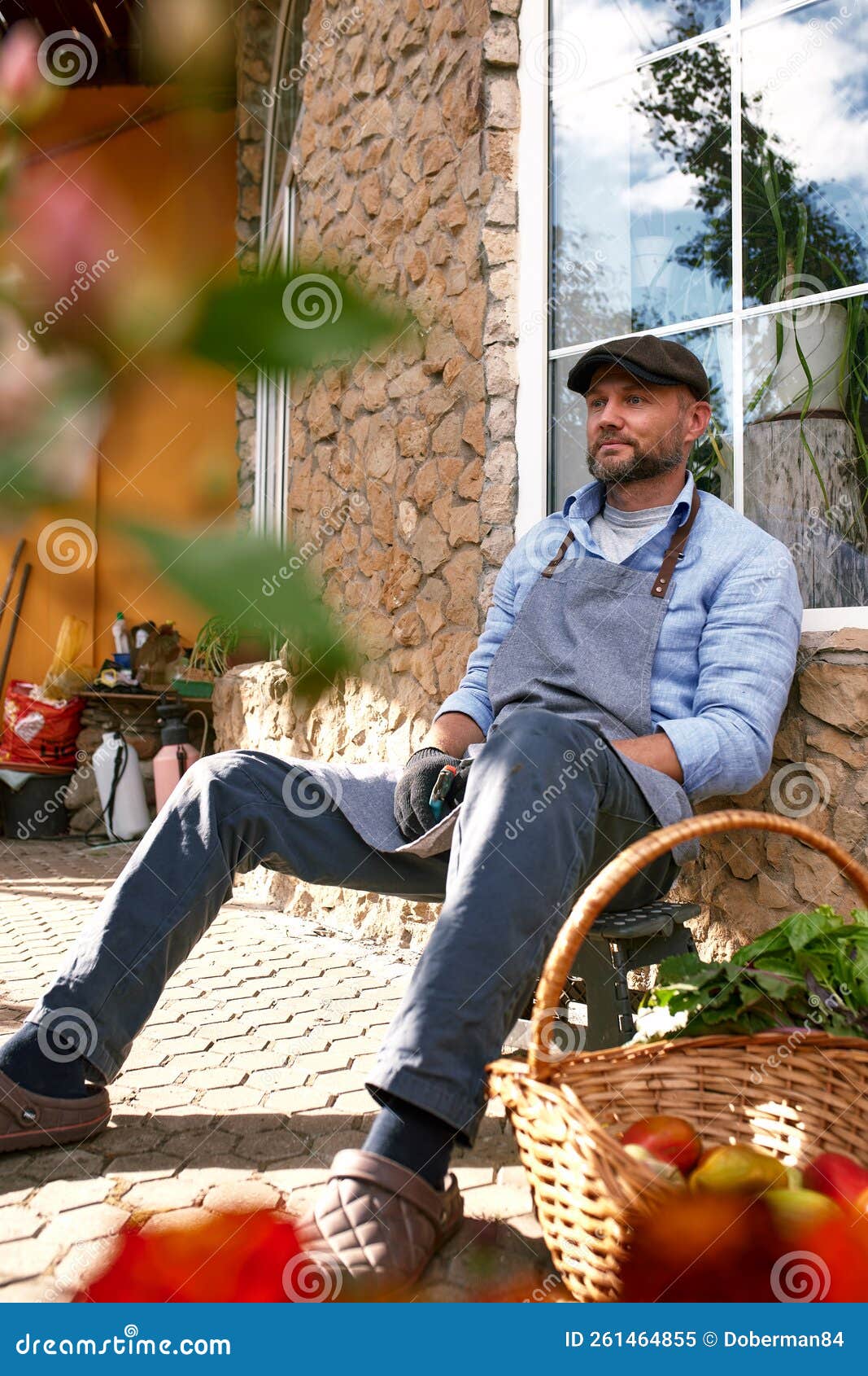 A Male Farmer Sitting in the Yard Outdoors, Resting. Stock Image ...