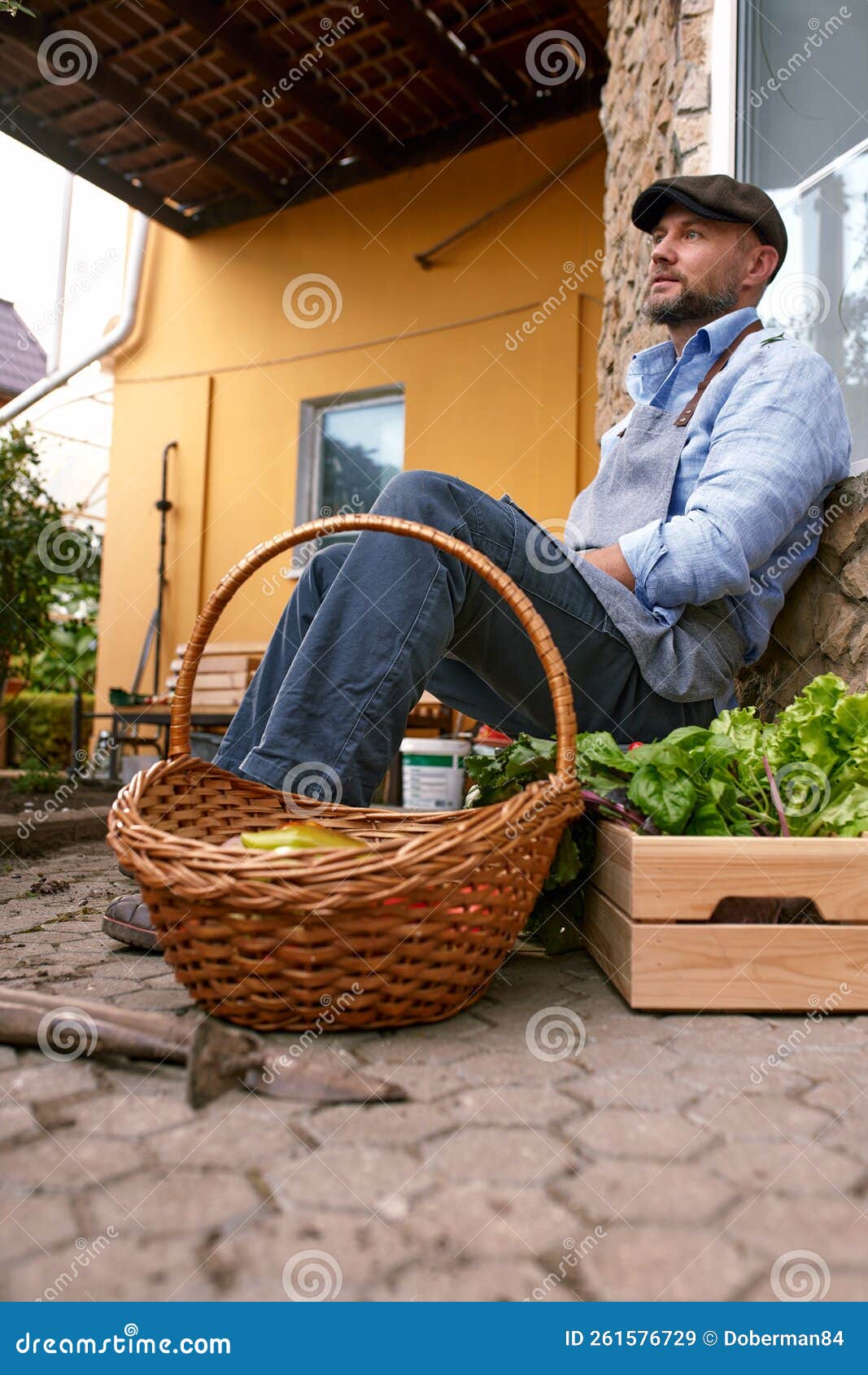 A Male Farmer Sitting in the Yard Outdoors, Resting. Stock Image ...