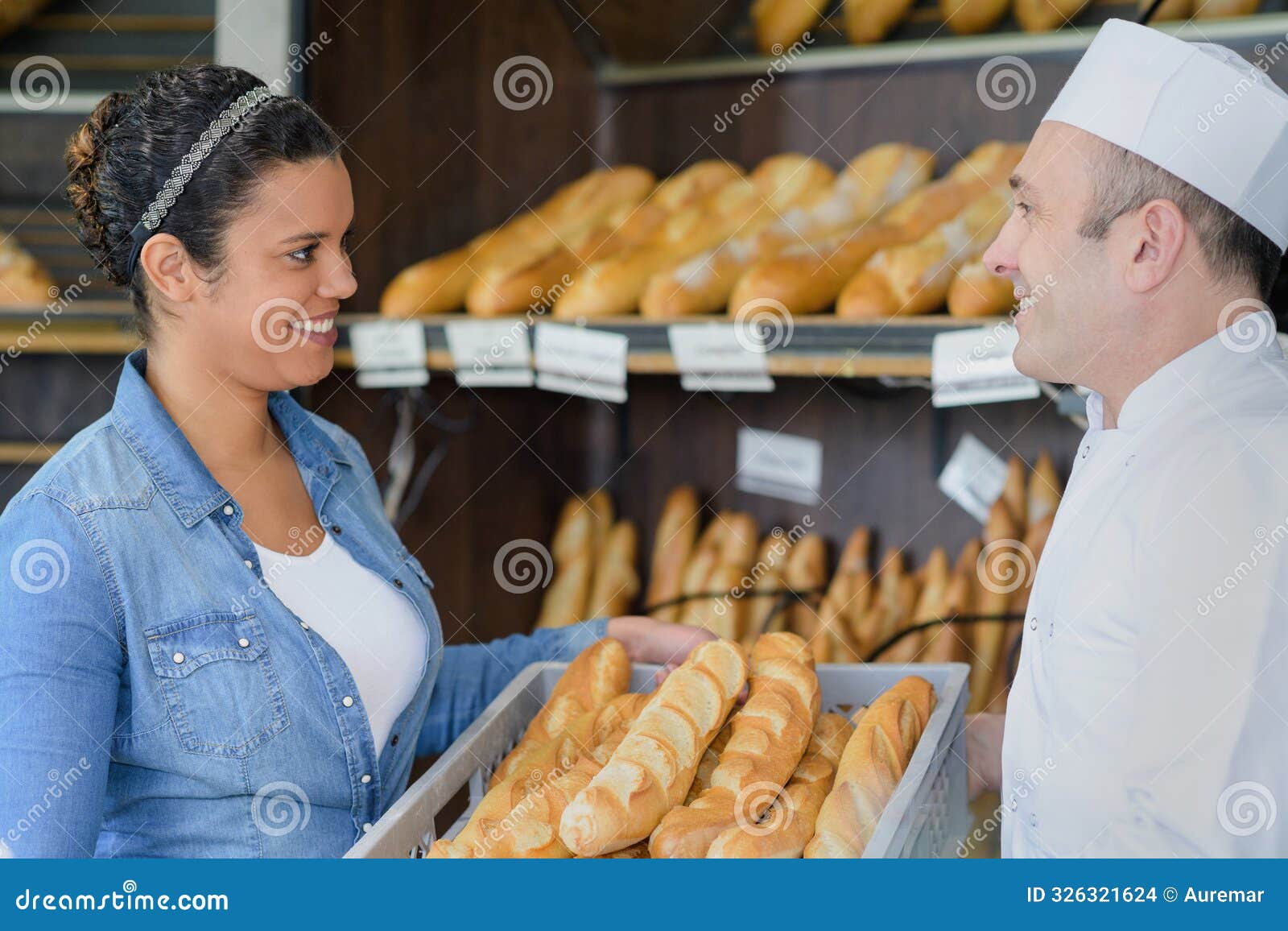 Male and Female Bakers Talking Over Counter Stock Photo - Image of ...