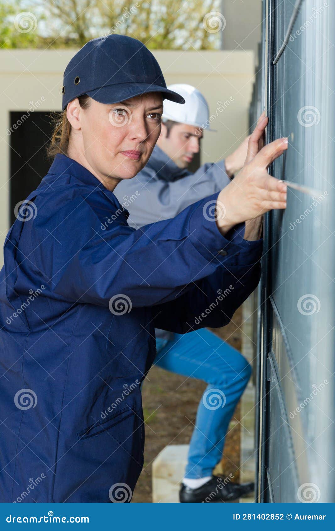 Male and Female Builders Working on Wall Stock Photo - Image of person ...