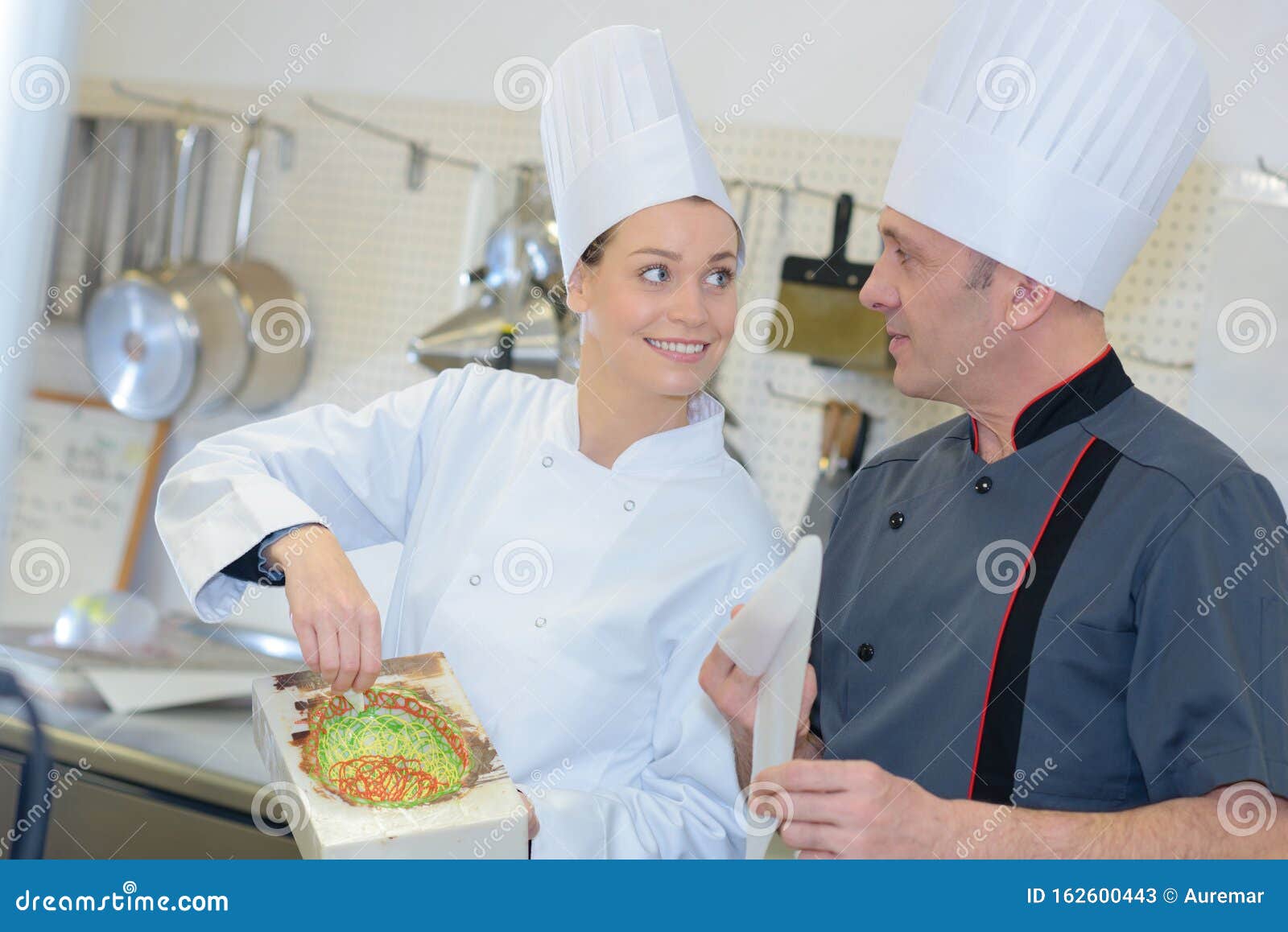 Male and Female Chefs Working at Kitchen Stock Image - Image of plate ...