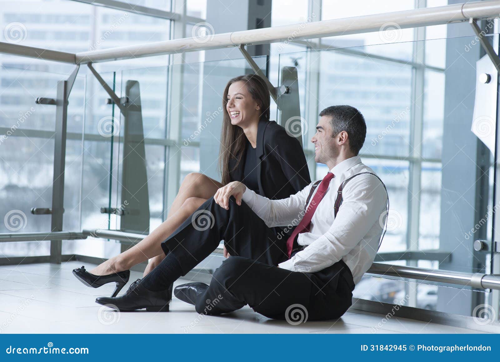 Male And Female Coworkers Sitting And Joking Together Royalty Free