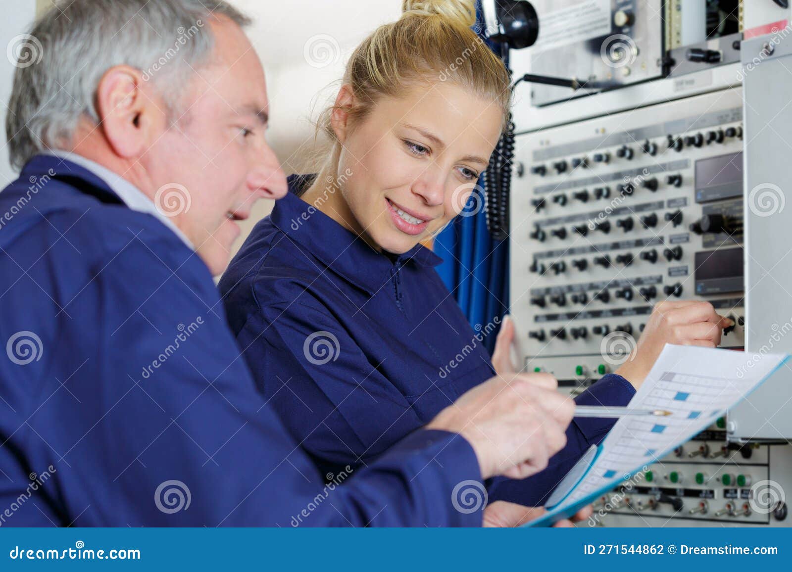 Male and Female Engineers Adjusting Aircraft Controls Stock Photo ...