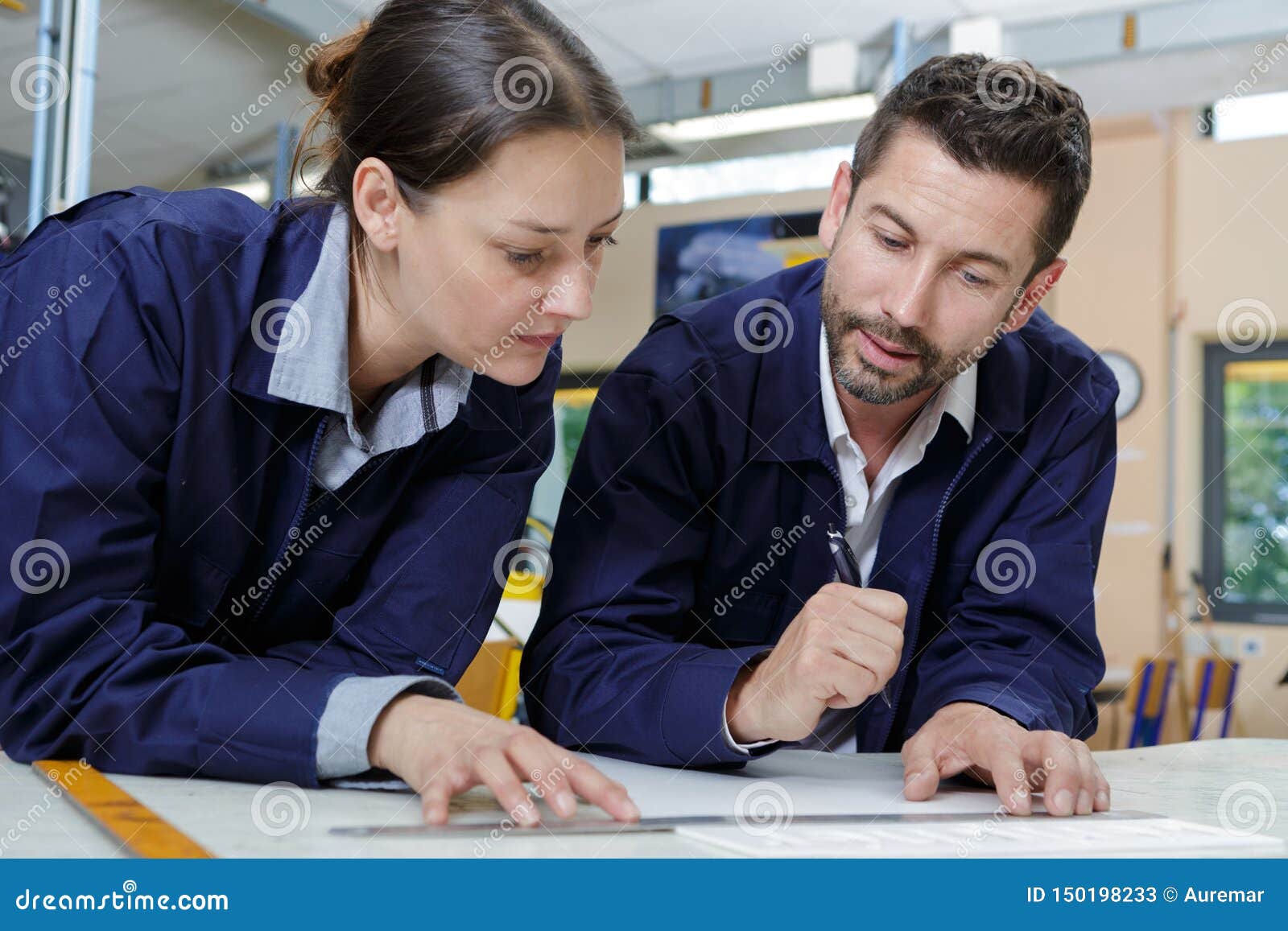 Male and Female Engineers in Discussion Over Desk Stock Image - Image ...